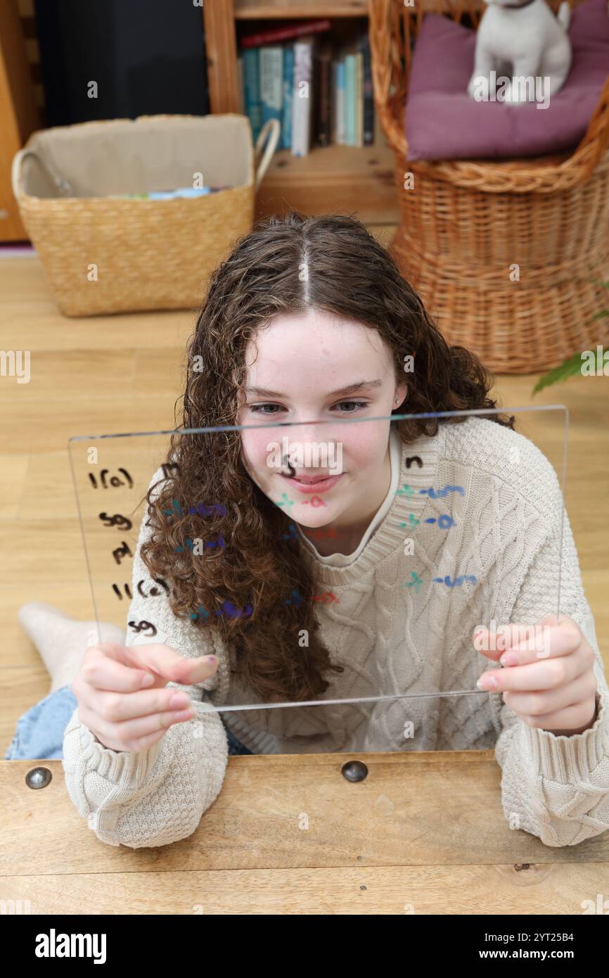 Teenage girl revising Latin on a whiteboard revision learning student ...