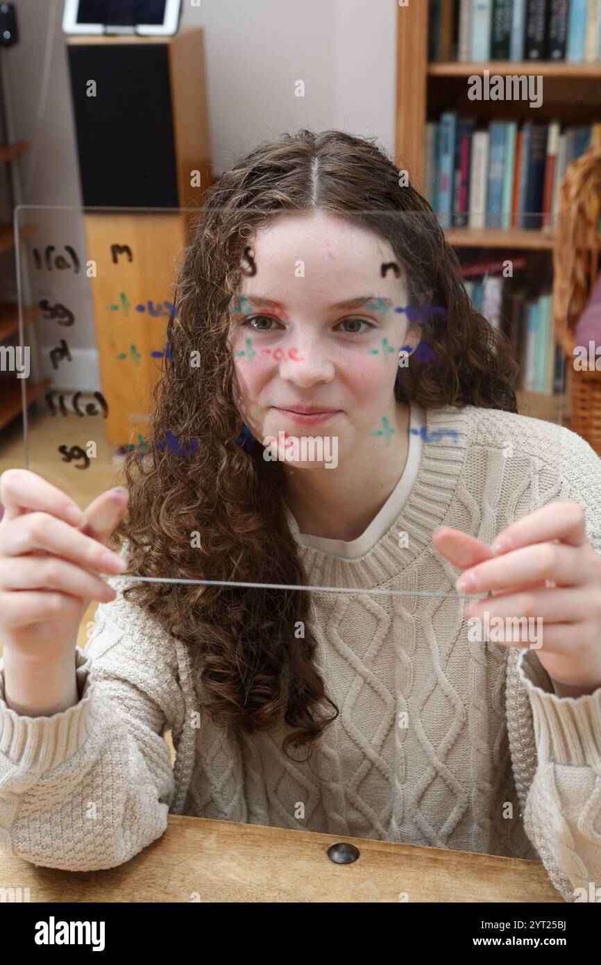 Teenage girl revising Latin on a whiteboard revision learning student ...