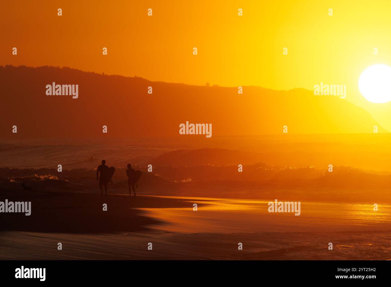Dec 1 2024. Ehukai Beach Park, Pupukea, Oahu, HI. Two surfers walk on ...