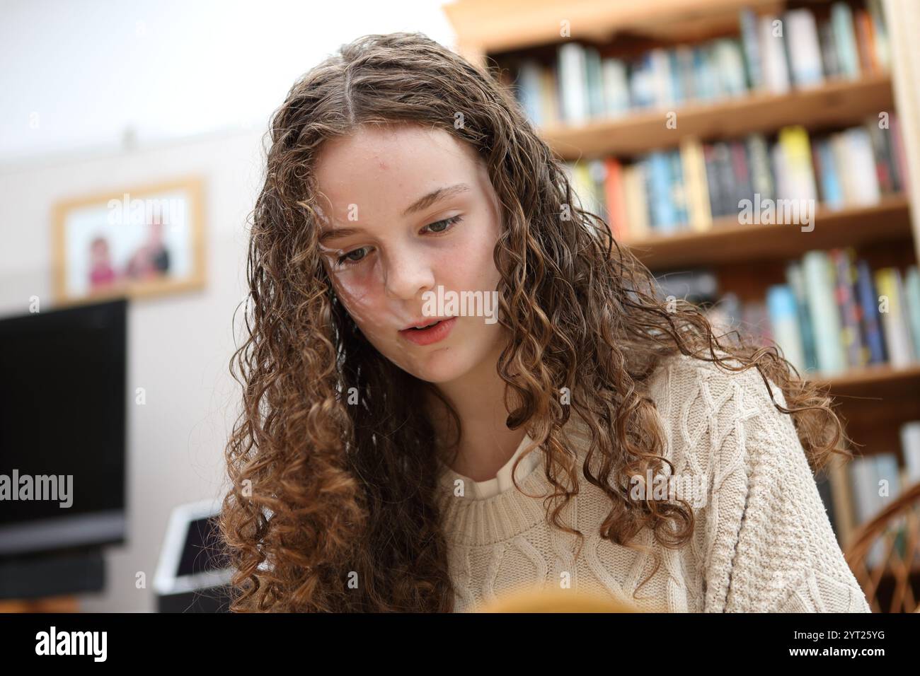 Teenage girl reading revising from a book studying learning Stock Photo ...