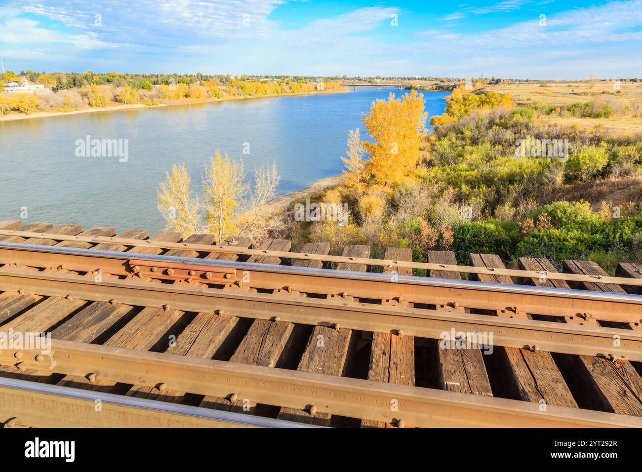 A train tracks with a river in the background. The train is not moving ...