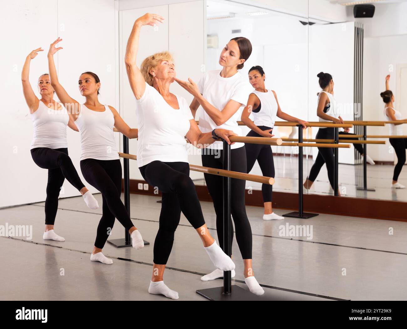 Female choreographer and group of multiracial dancers in dance school ...