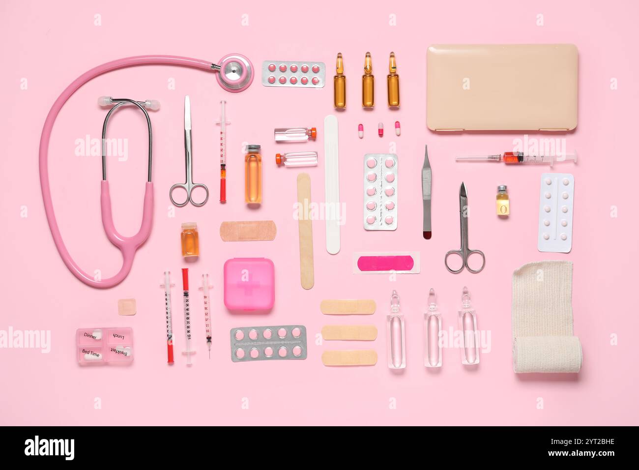 Medical supplies with stethoscope, insulin syringe and patch on pink ...