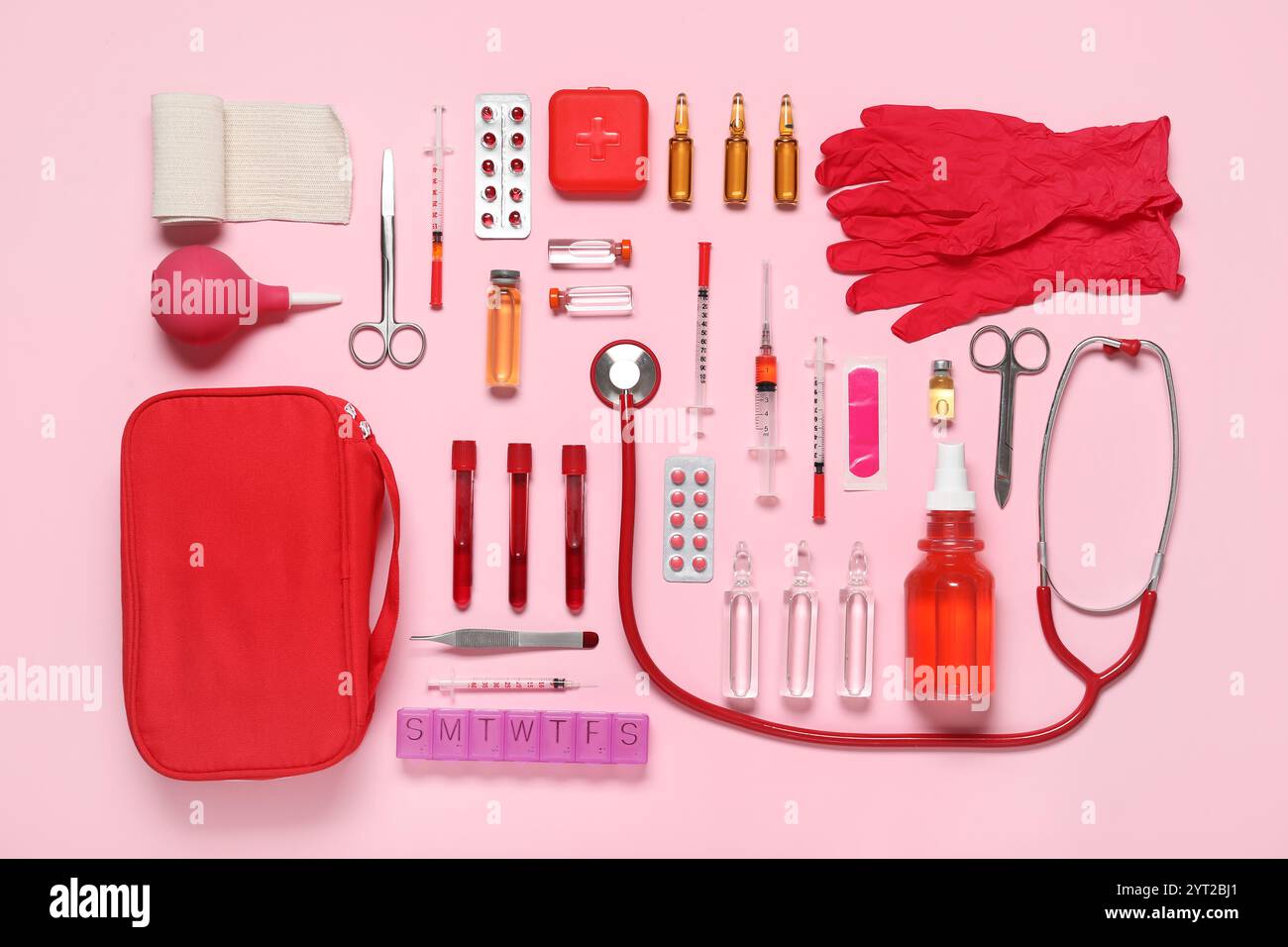 Medical supplies with insulin syringe, enema and stethoscope on pink ...