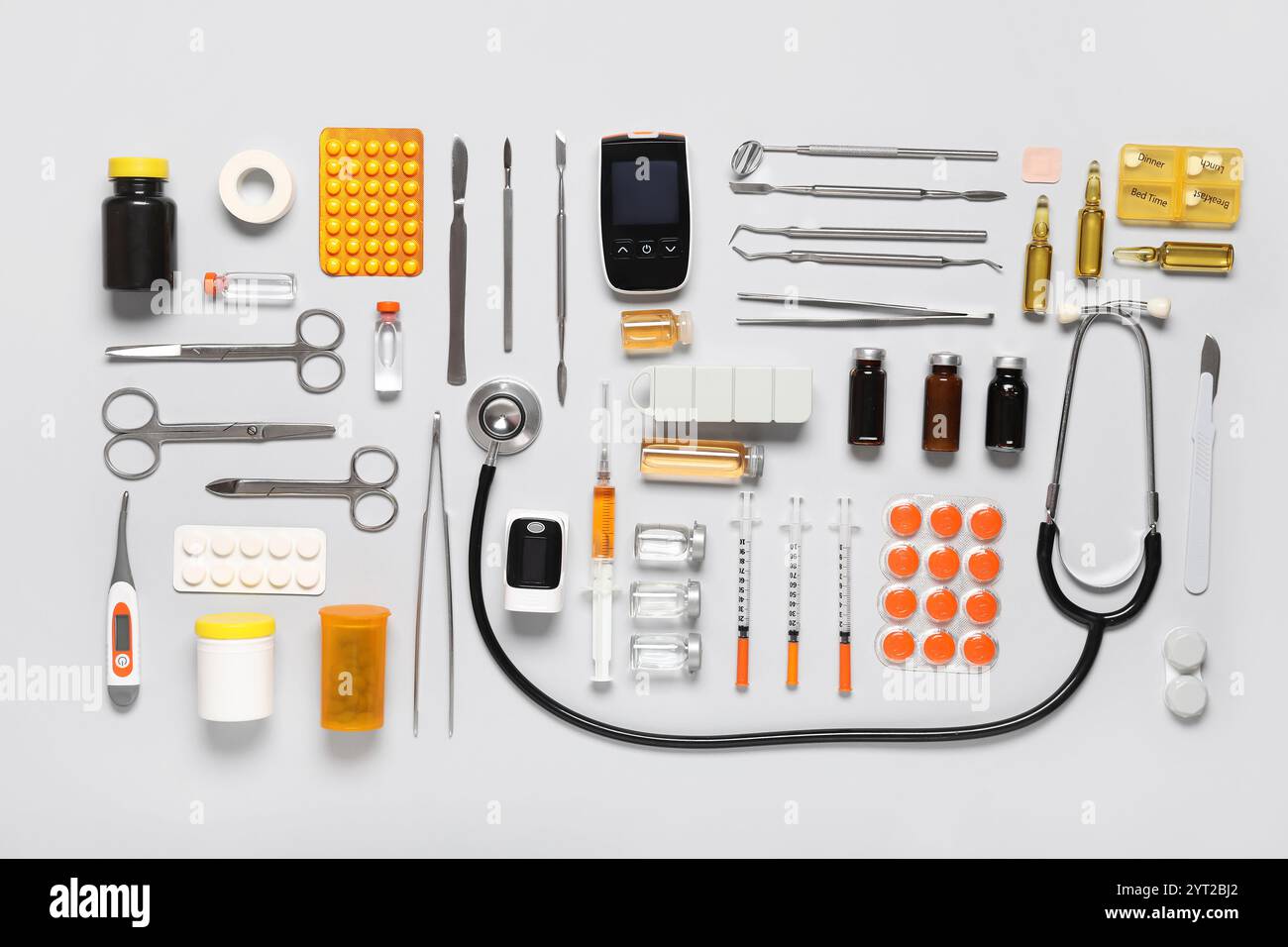 Medical supplies with insulin syringe and stethoscope on grey ...