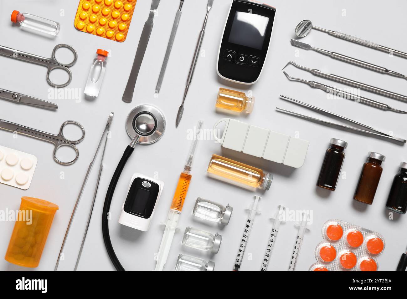 Medical supplies with insulin syringe and stethoscope on grey ...