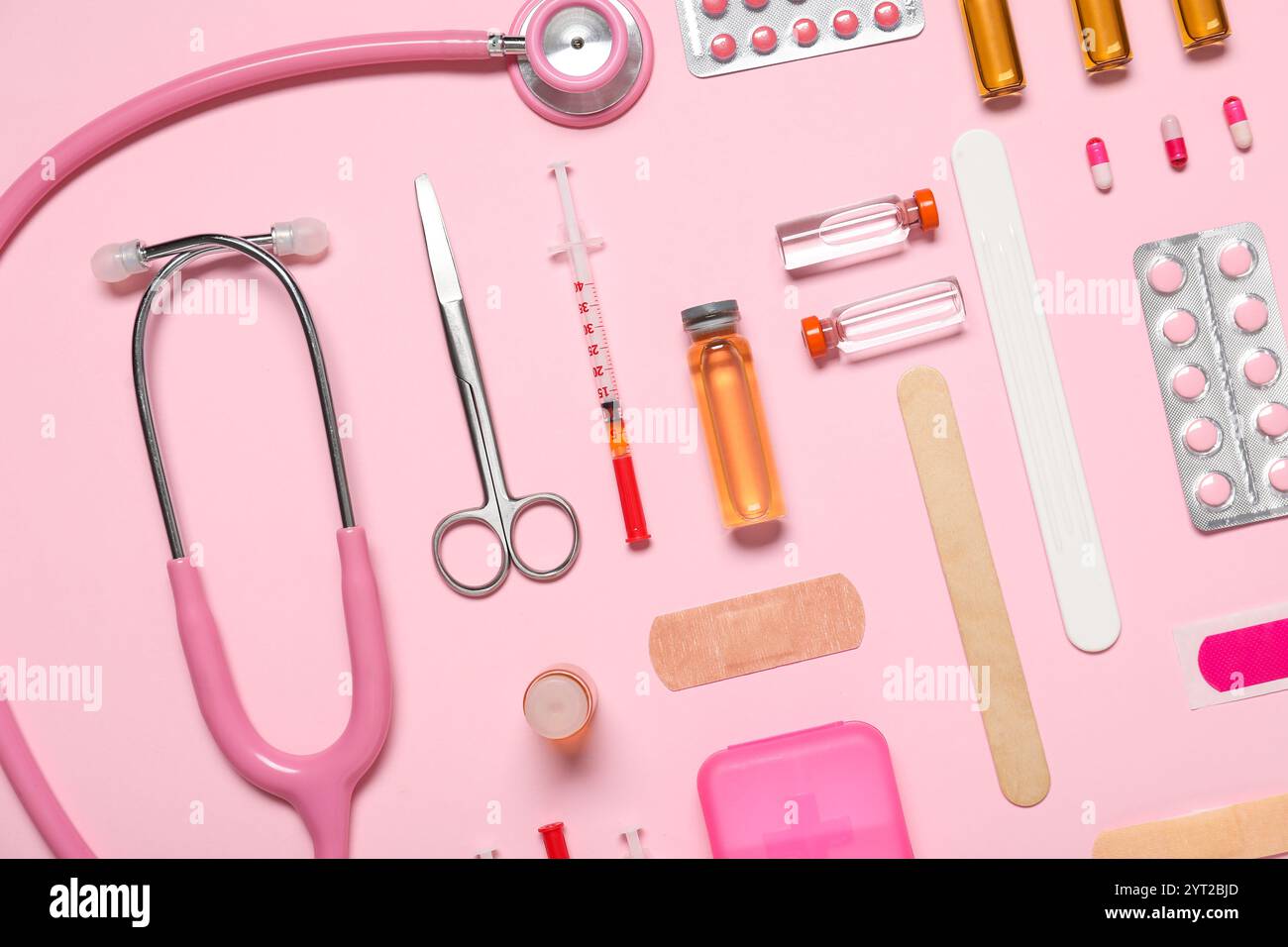 Medical supplies with stethoscope, insulin syringe and patch on pink ...