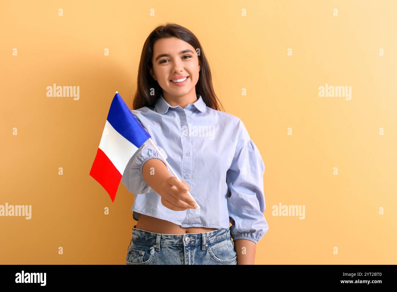 Female French language teacher with flag on yellow background Stock ...
