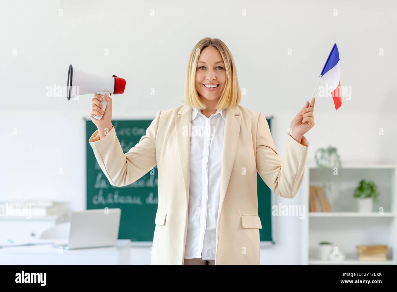 Female French language teacher with flag and megaphone in light ...