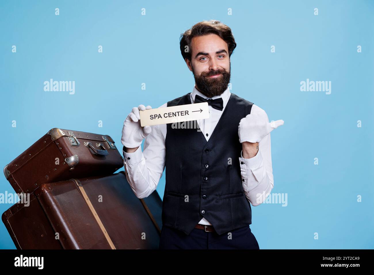 Hotel concierge shows direction of spa center using indicator, pointing ...