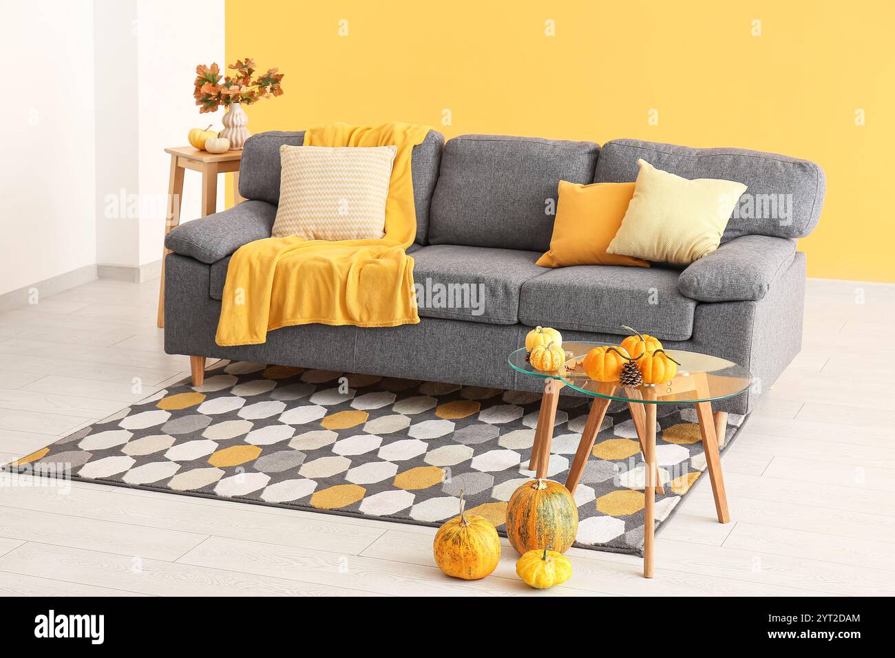 Interior of living room with autumn decor, sofa and tables Stock Photo ...