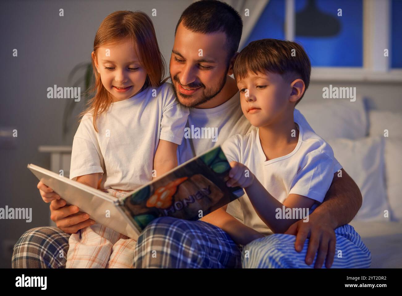 Father reading book for his children in bedroom Stock Photo - Alamy
