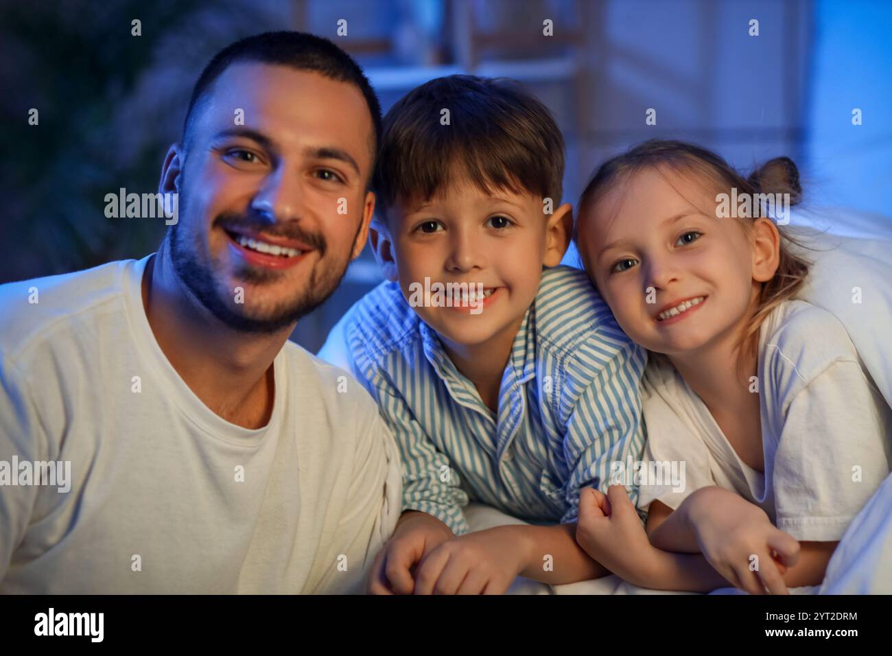 Father and his cute little children before going to sleep Stock Photo ...