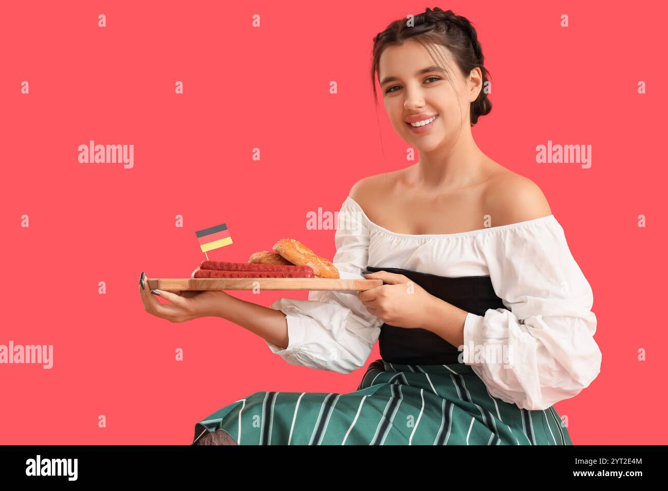 Young Octoberfest waitress with traditional German food on red ...