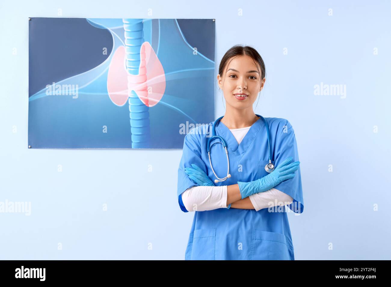 Female Asian endocrinologist against picture of thyroid gland on blue ...
