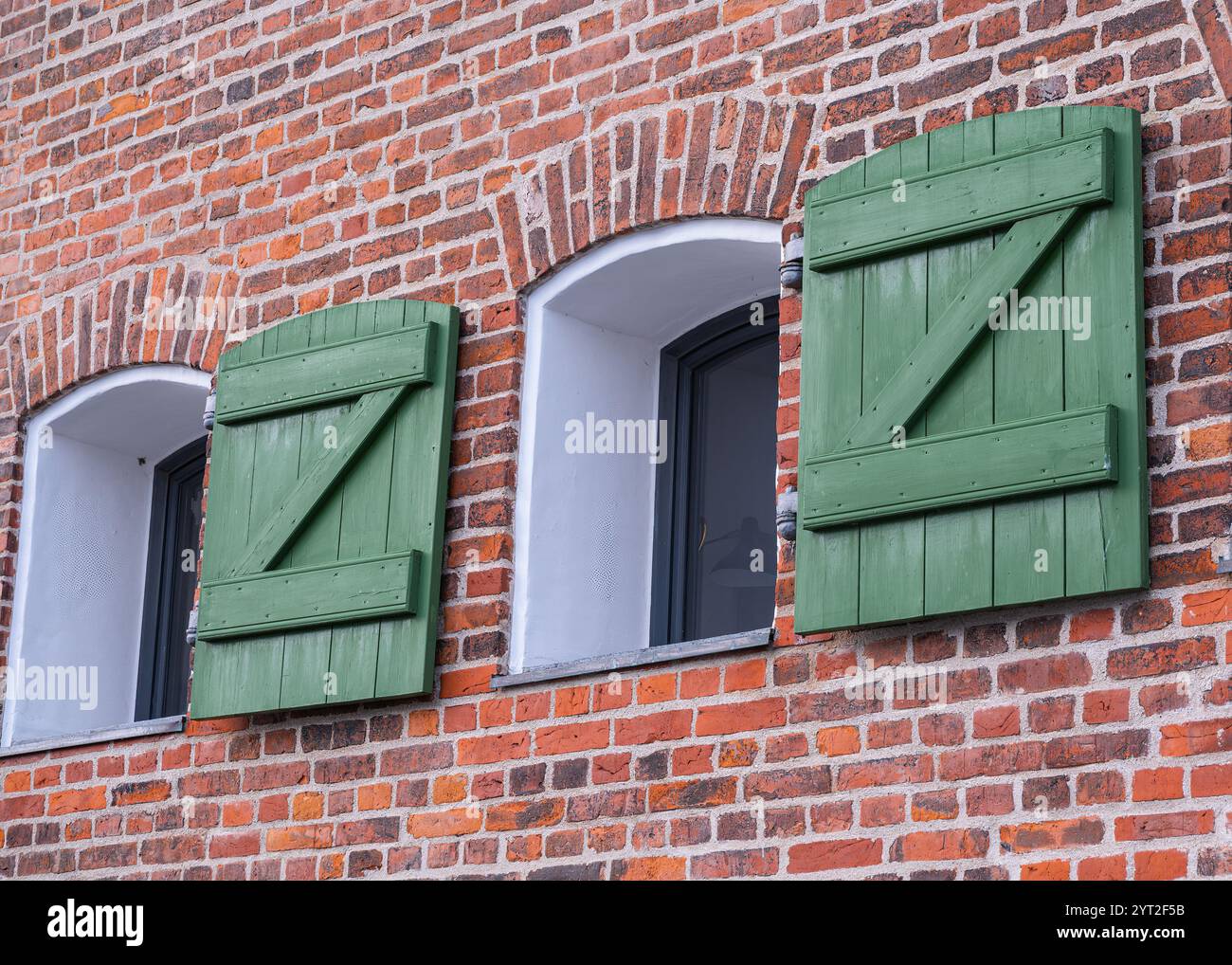 o windows with vibrant green shutters, featuring rustic diagonal ...