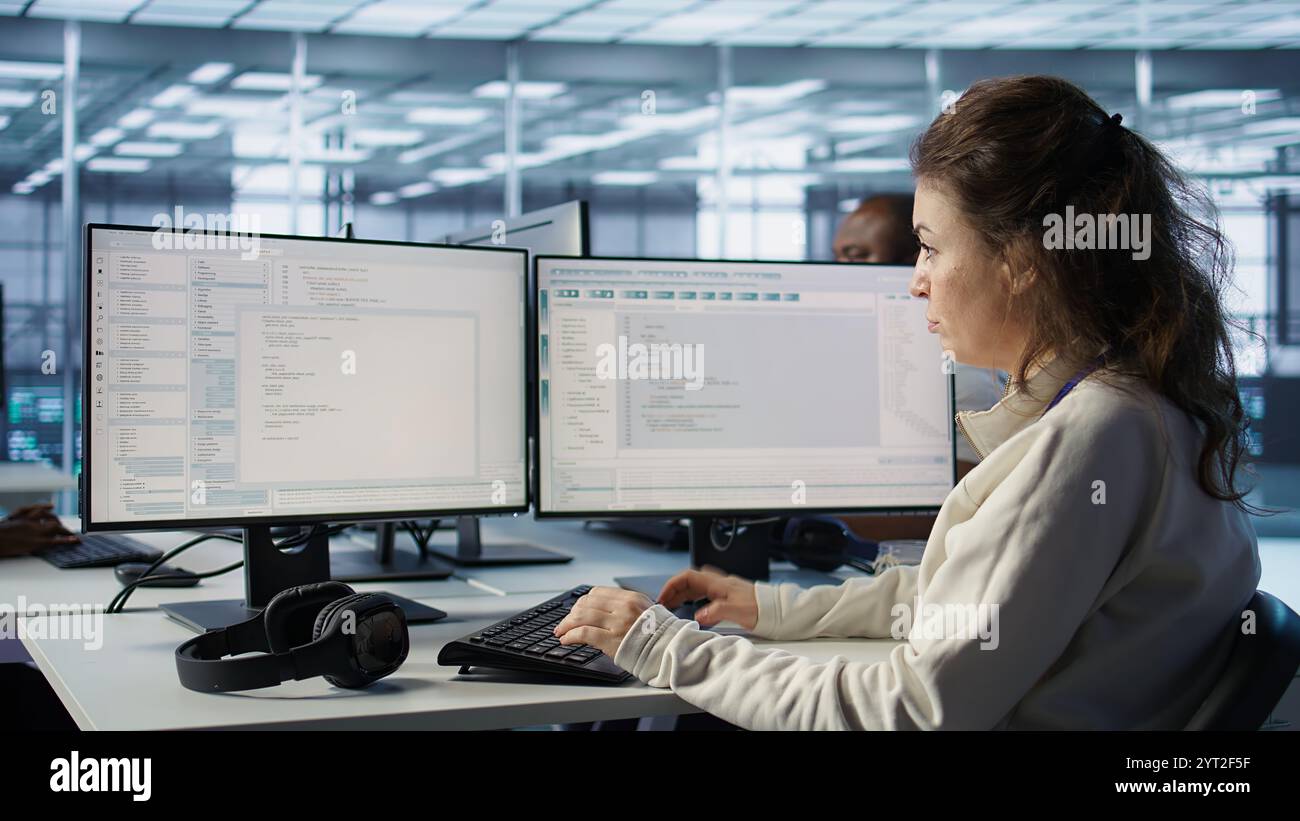 IT professional in server hub ensuring valuable data remains shielded from potential threats ...