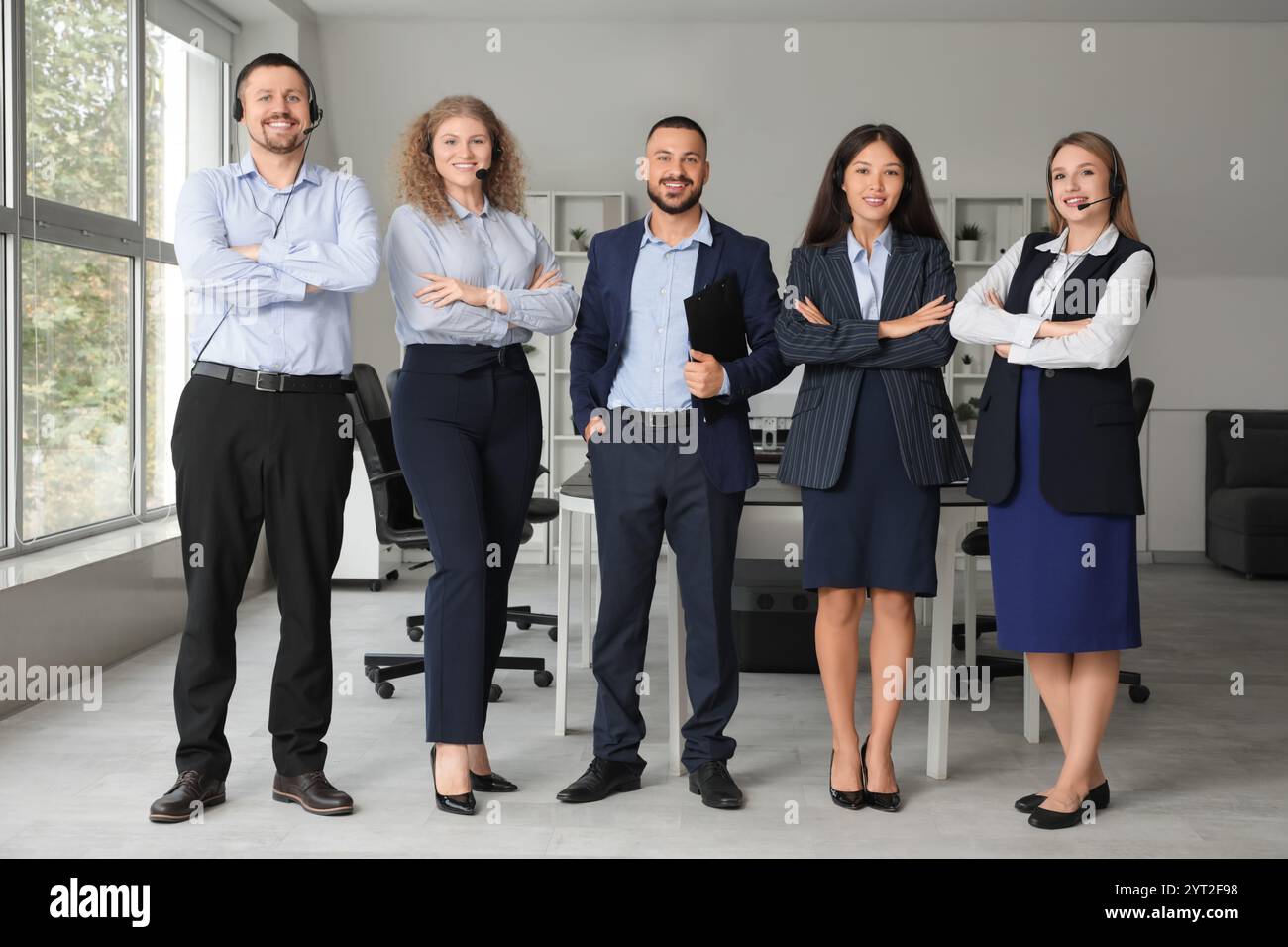Technical support agents with headsets in office Stock Photo - Alamy