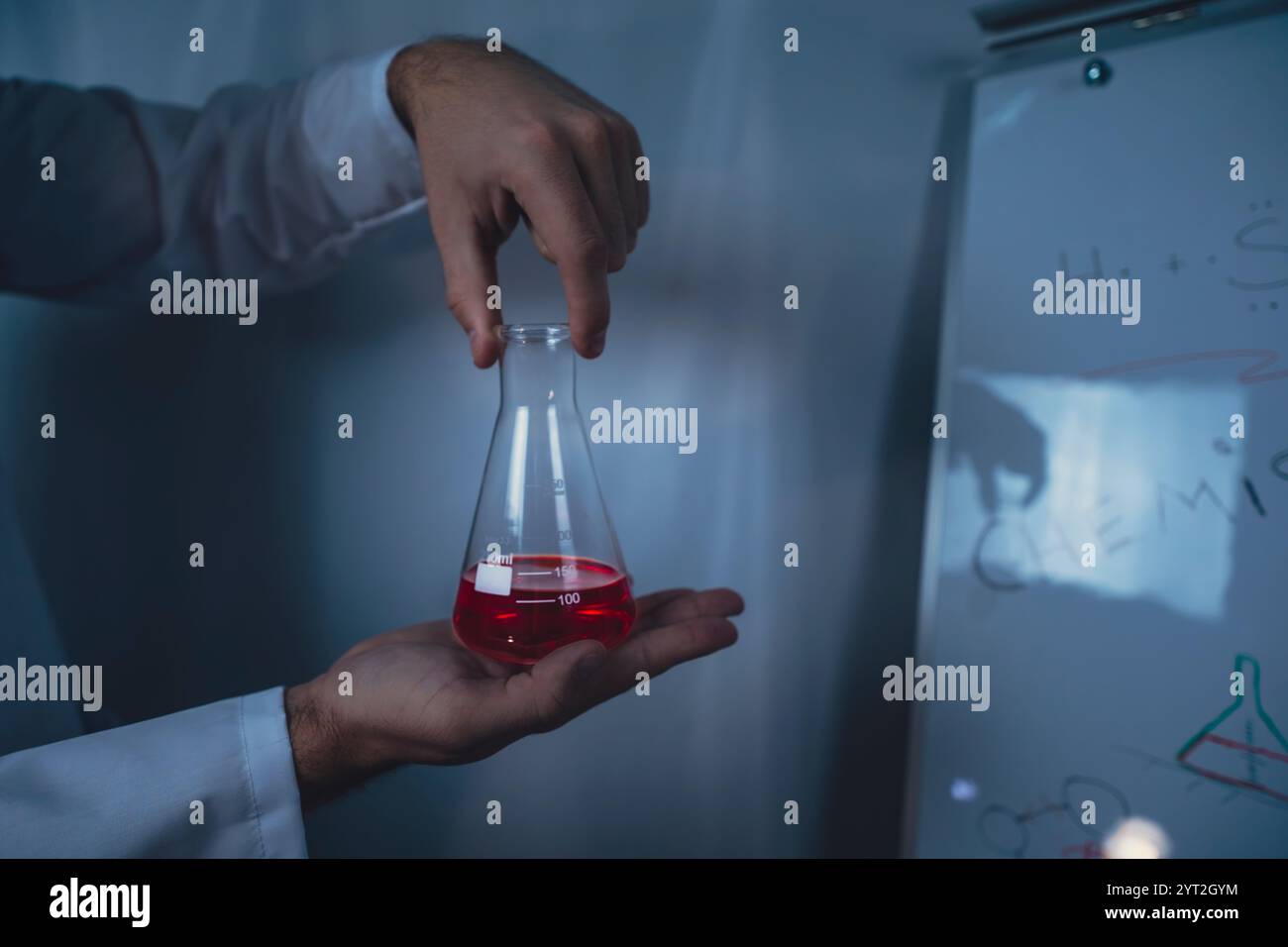 A scientist works with test tubes containing colorful liquids in a ...
