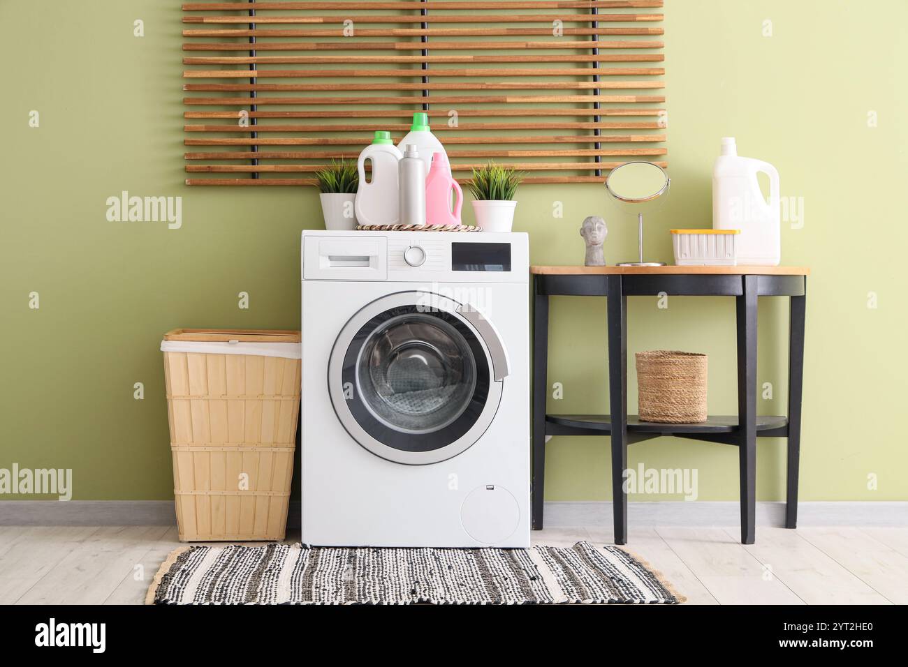 Interior of laundry room with wooden folding screen, washing machine ...