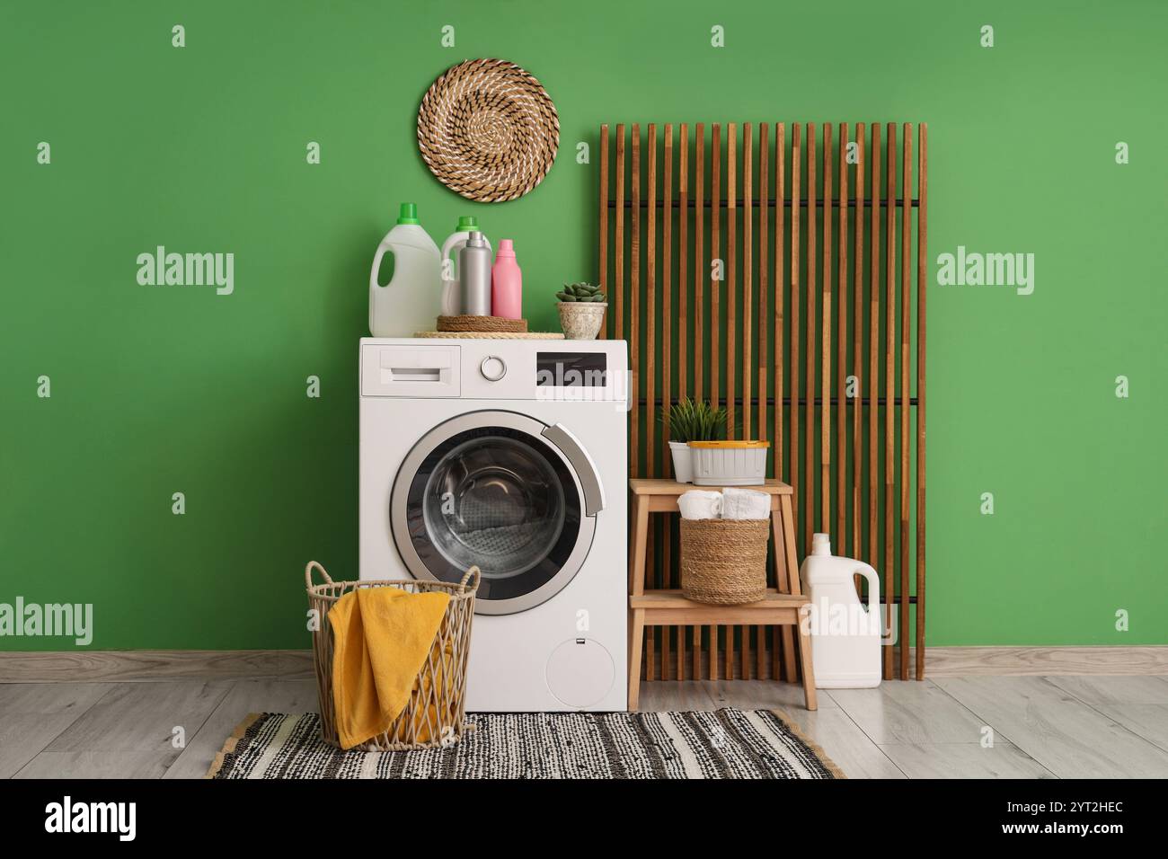 Interior of laundry room with wooden folding screen, washing machine ...