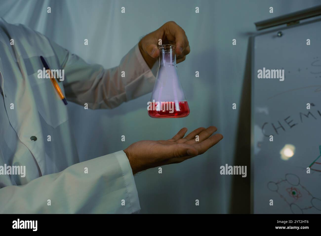 A scientist works with test tubes containing colorful liquids in a ...