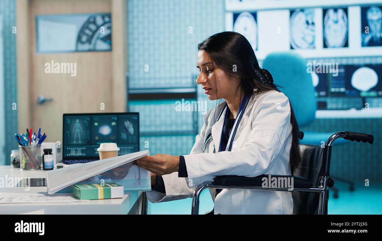 Indian female physician with disability consulting a patient in office ...