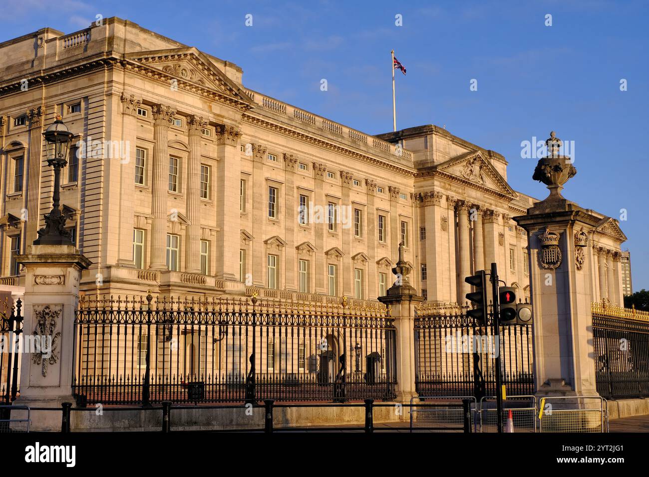 Buckingham Palace glowing orange soon after sunrise in London, England ...