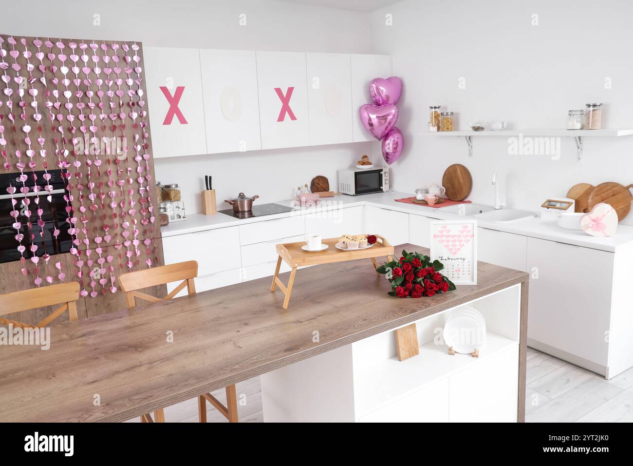 Interior of festive kitchen with hearts, roses and heart-shaped ...