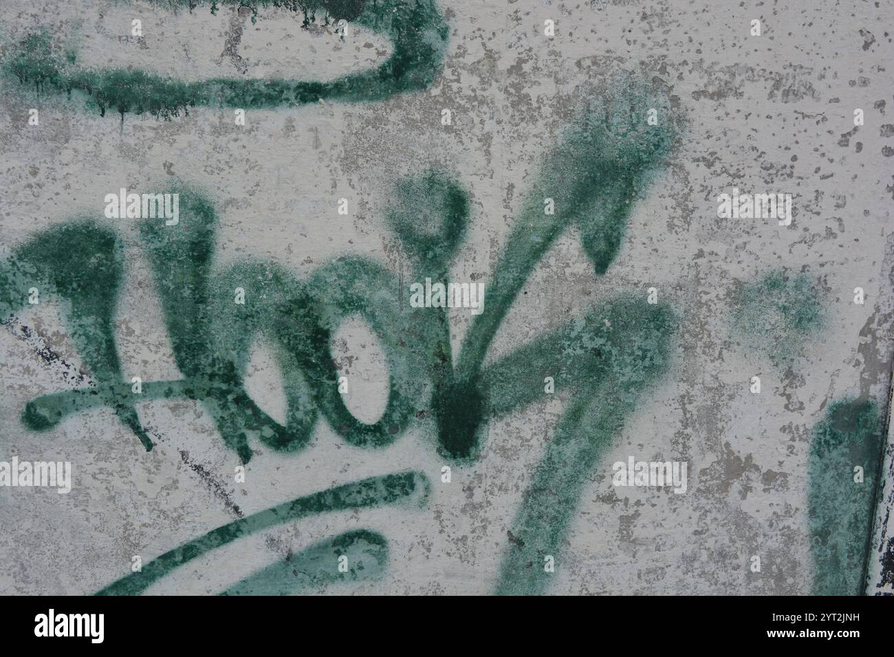 Graffiti, inscriptions on an old reinforced concrete fence, brick walls ...