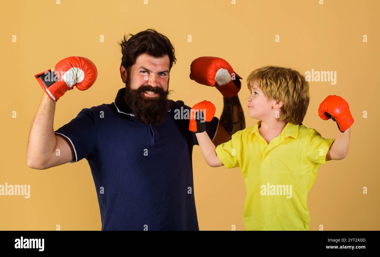 Father and son in boxing gloves in boxing ring. Little child boy boxer ...