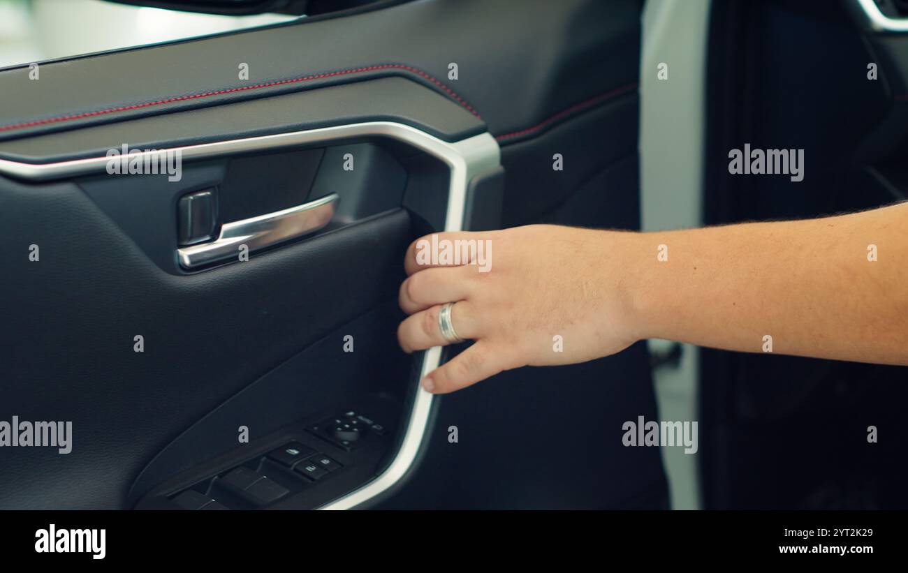 Close up shot of person closing car after using lock controls on panel ...