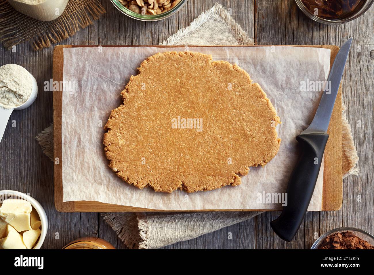 Rolled out dough made of whey protein powder, maple syrup and peanut ...