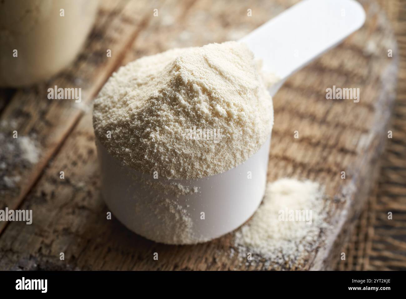 Whey protein powder in a white measuring cup Stock Photo - Alamy