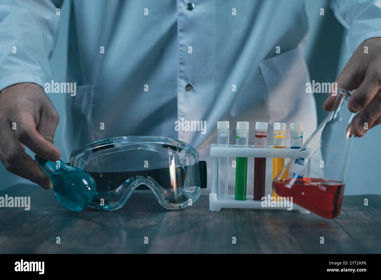 A laboratory setup featuring colorful test tubes, safety goggles, and ...