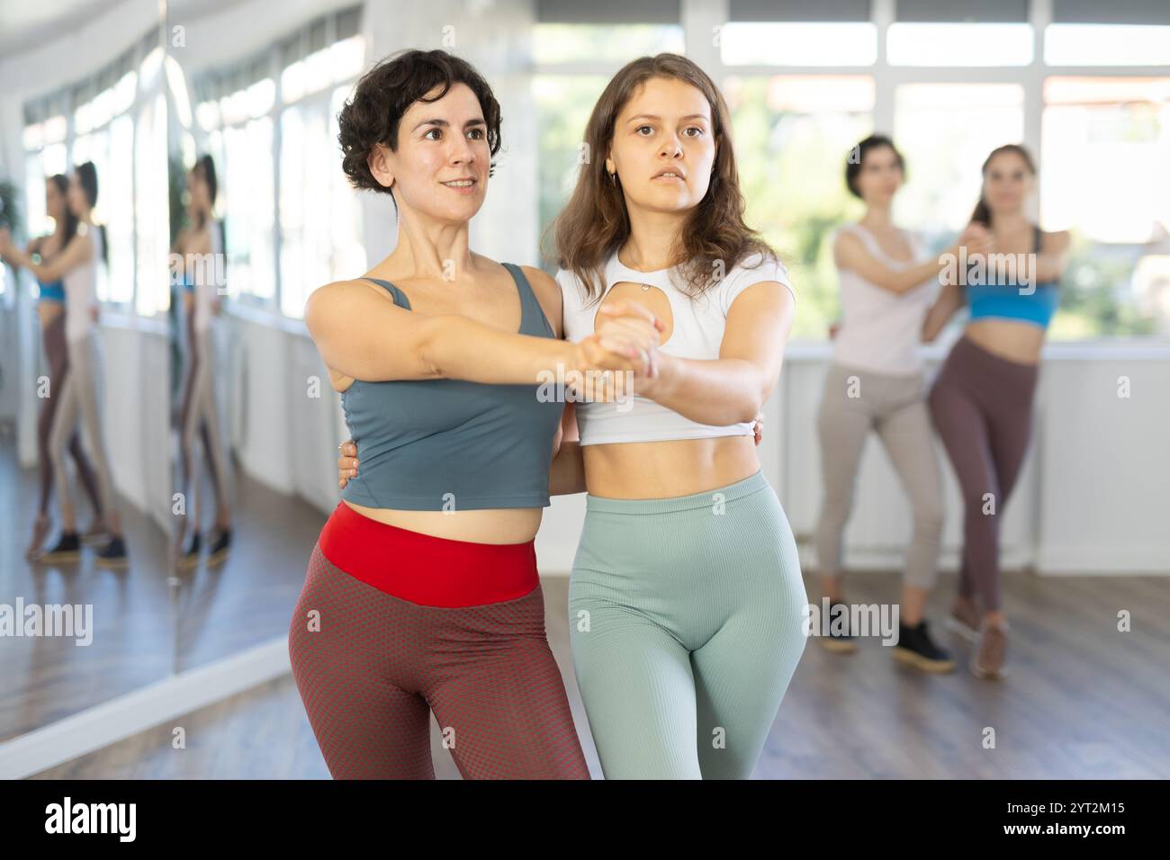 Group of women dancing pair dances in studio Stock Photo - Alamy