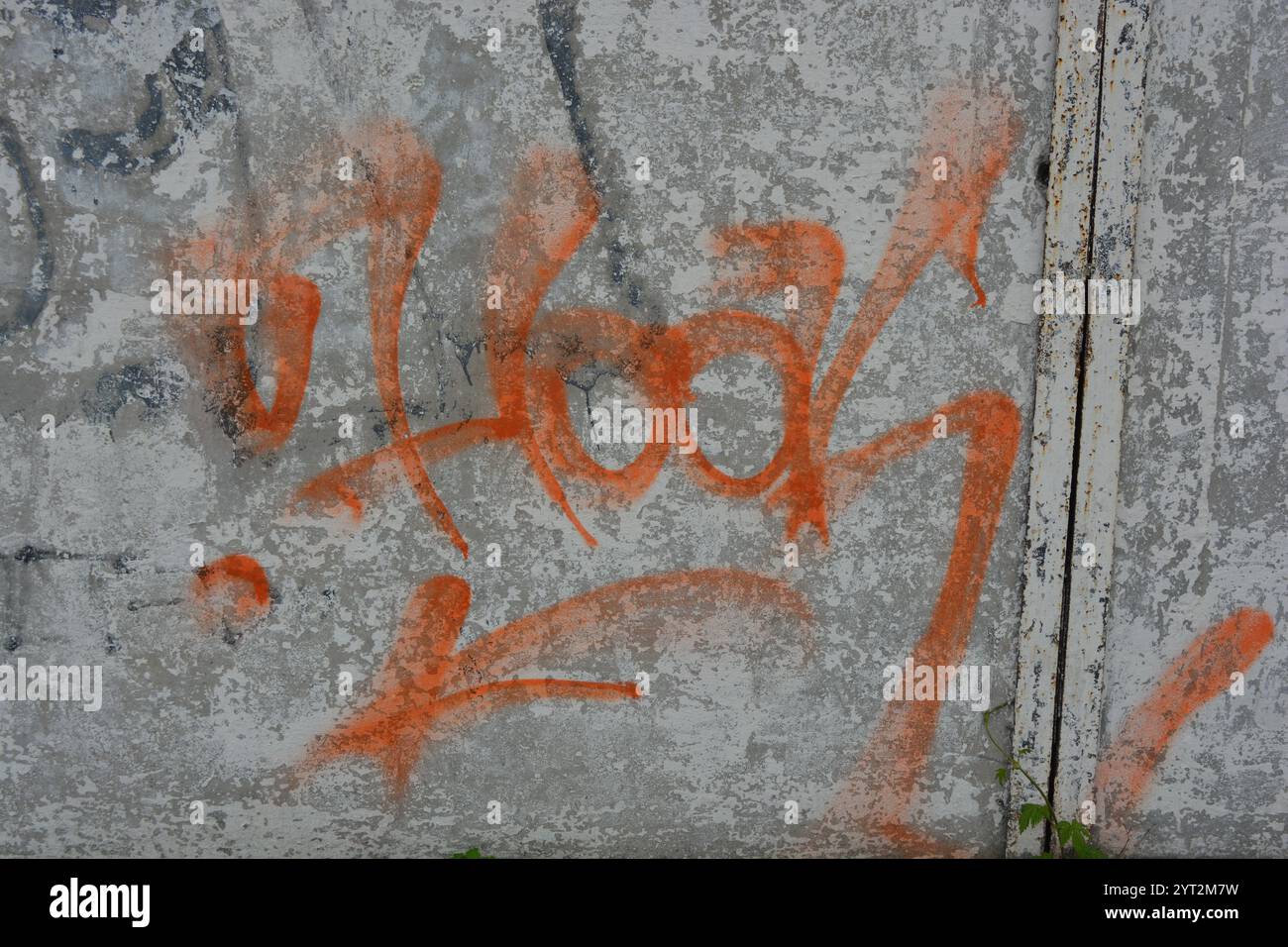 Drawings, graffiti, inscriptions on an old reinforced concrete fence ...