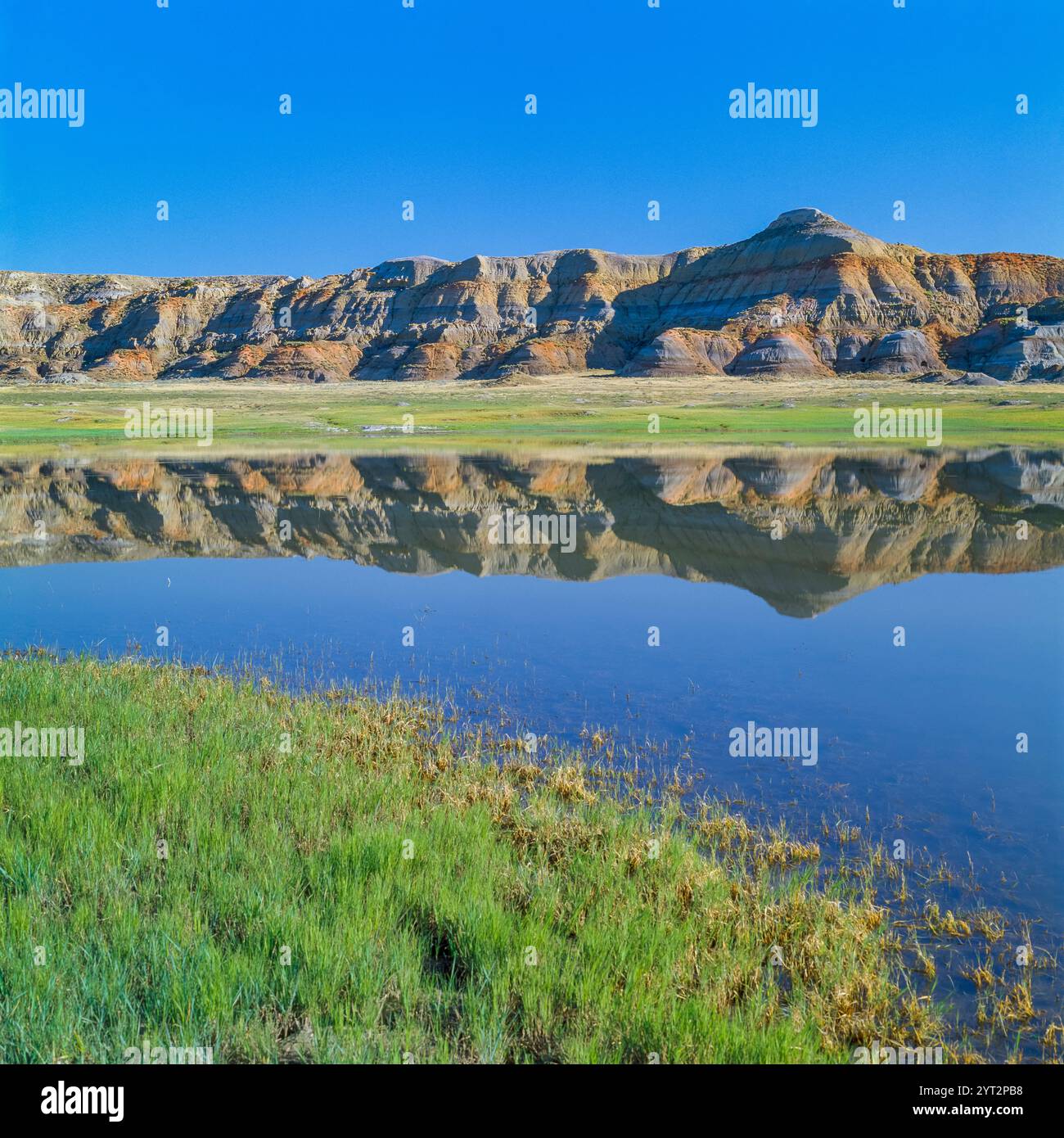 badlands reflected in a bay of dry arm in fort peck lake near van ...