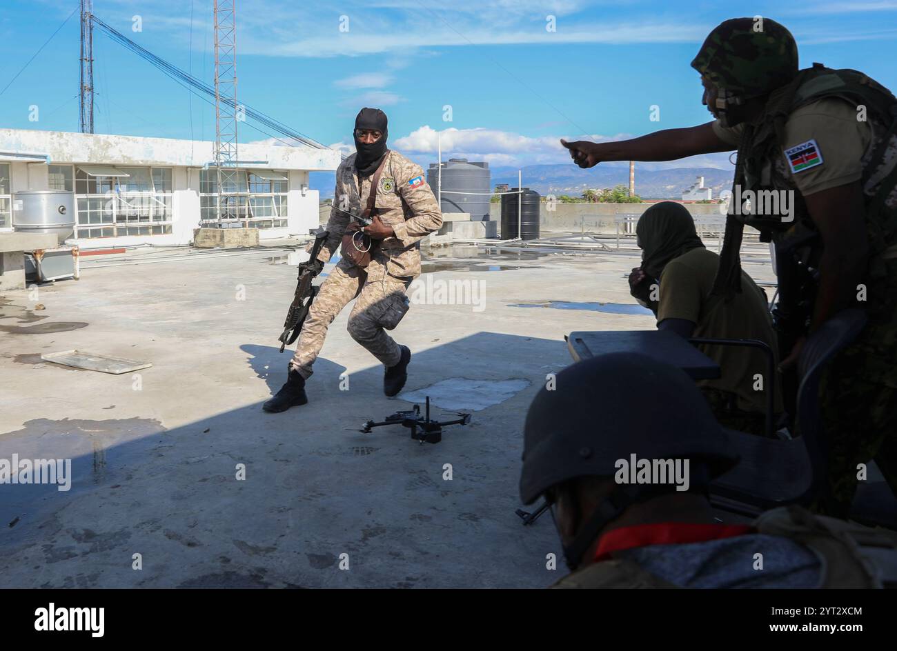 A Haitian police officer runs to take cover with Kenyan police officers ...