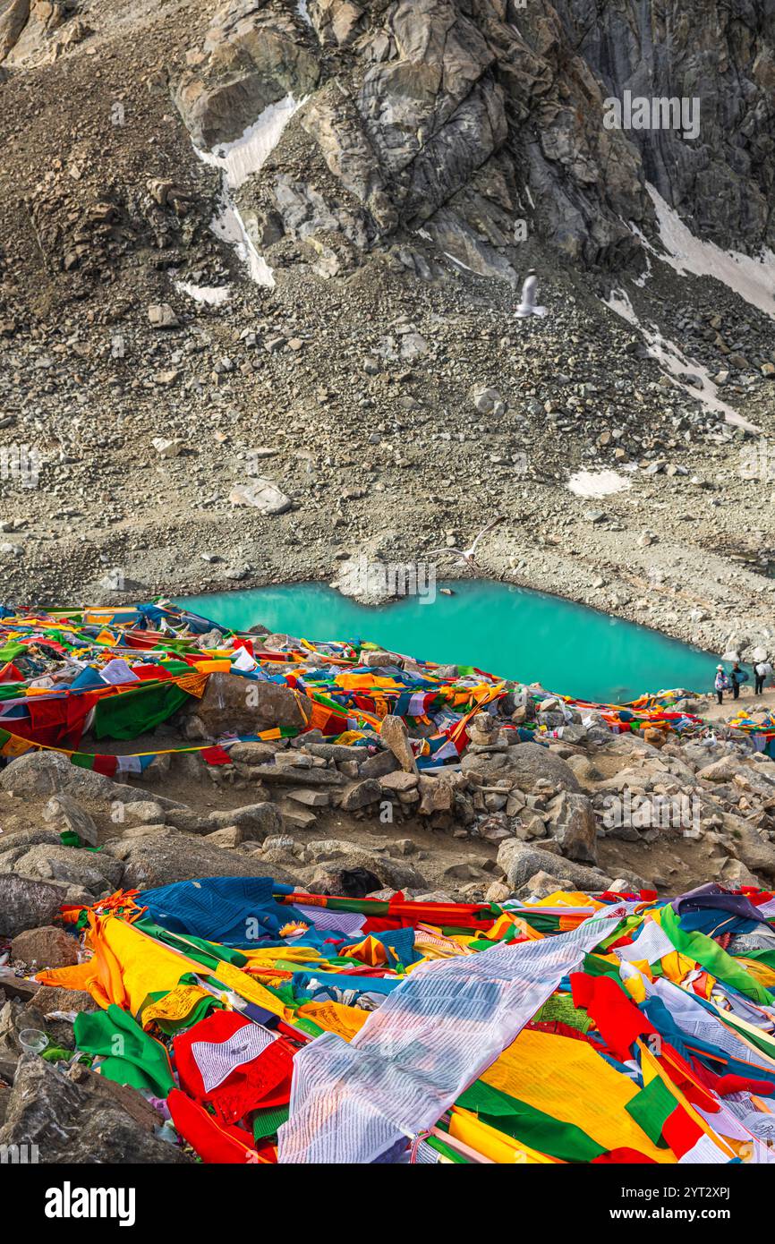 Tibetan praying flags at the Gauri Kund mountain lake during the ritual ...