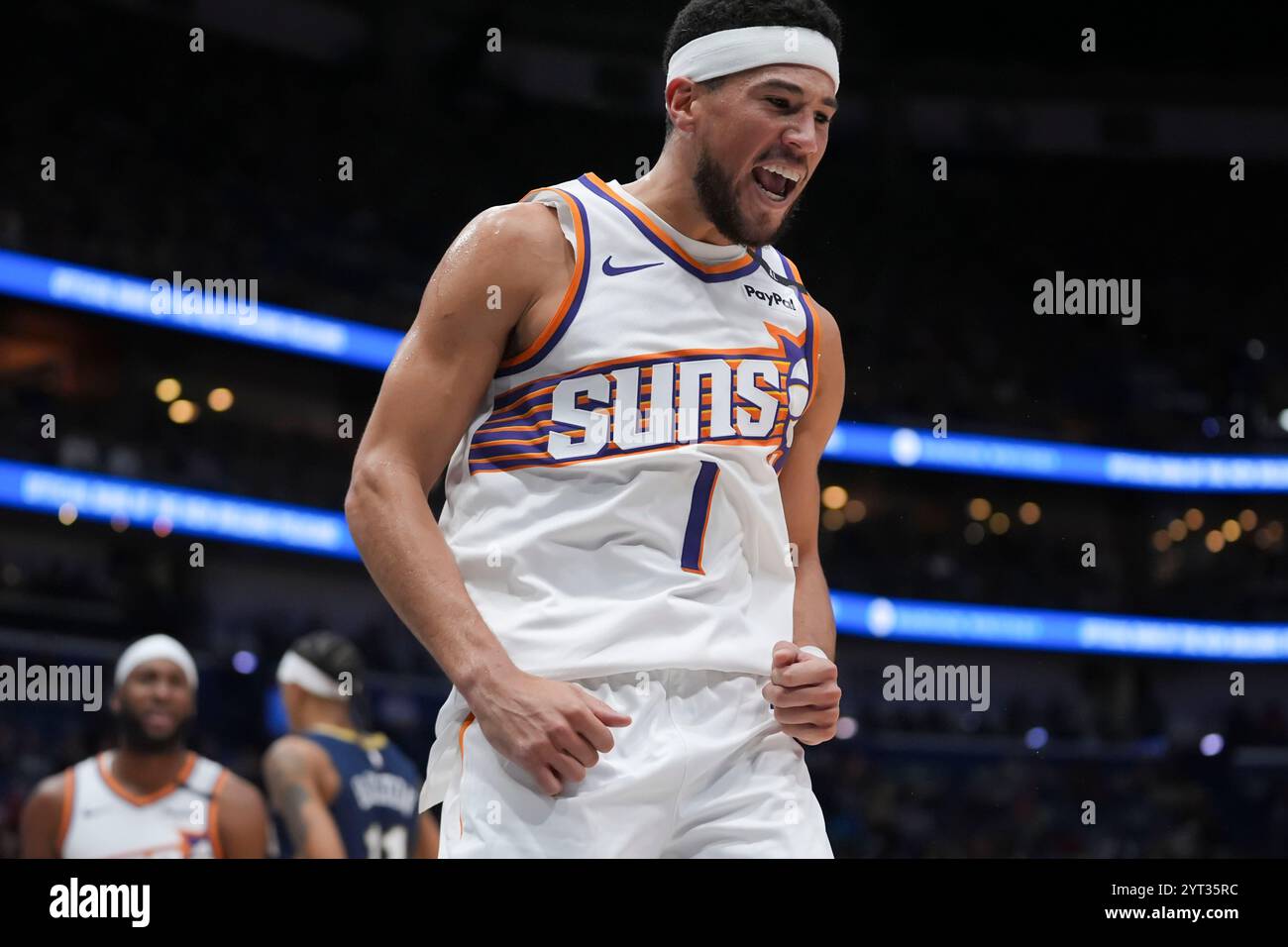 Phoenix Suns guard Devin Booker (1) reacts after missing a basket while being fouled in the ...