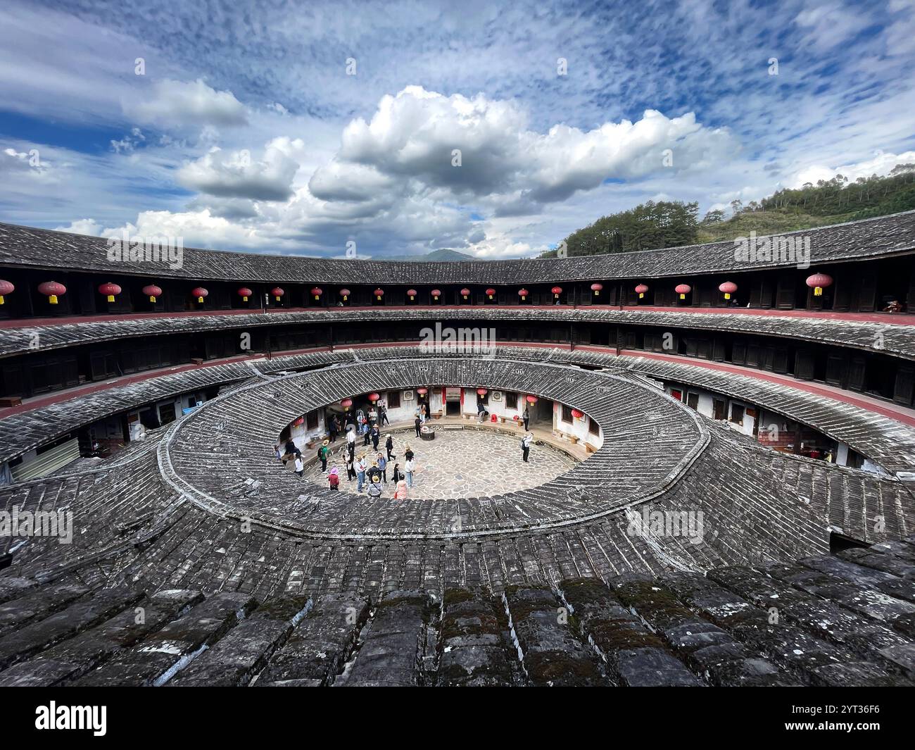 Hua'an,China.3rd December 2024. Tourists explore the charm of earth buildings and feel the charm ...