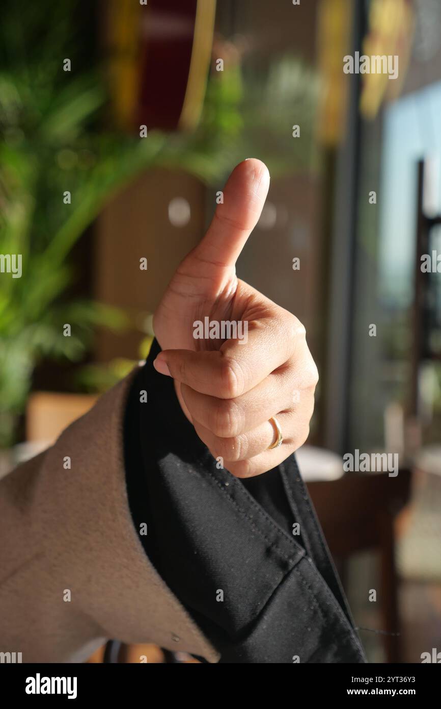 A Cheerful and Positive Thumbs Up Gesture in a Contemporary Modern ...