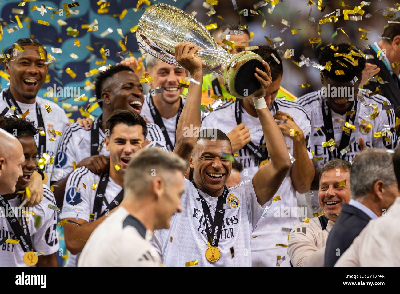 Kylian Mbappe (C) of Real Madrid celebrates victory with trophy during ...