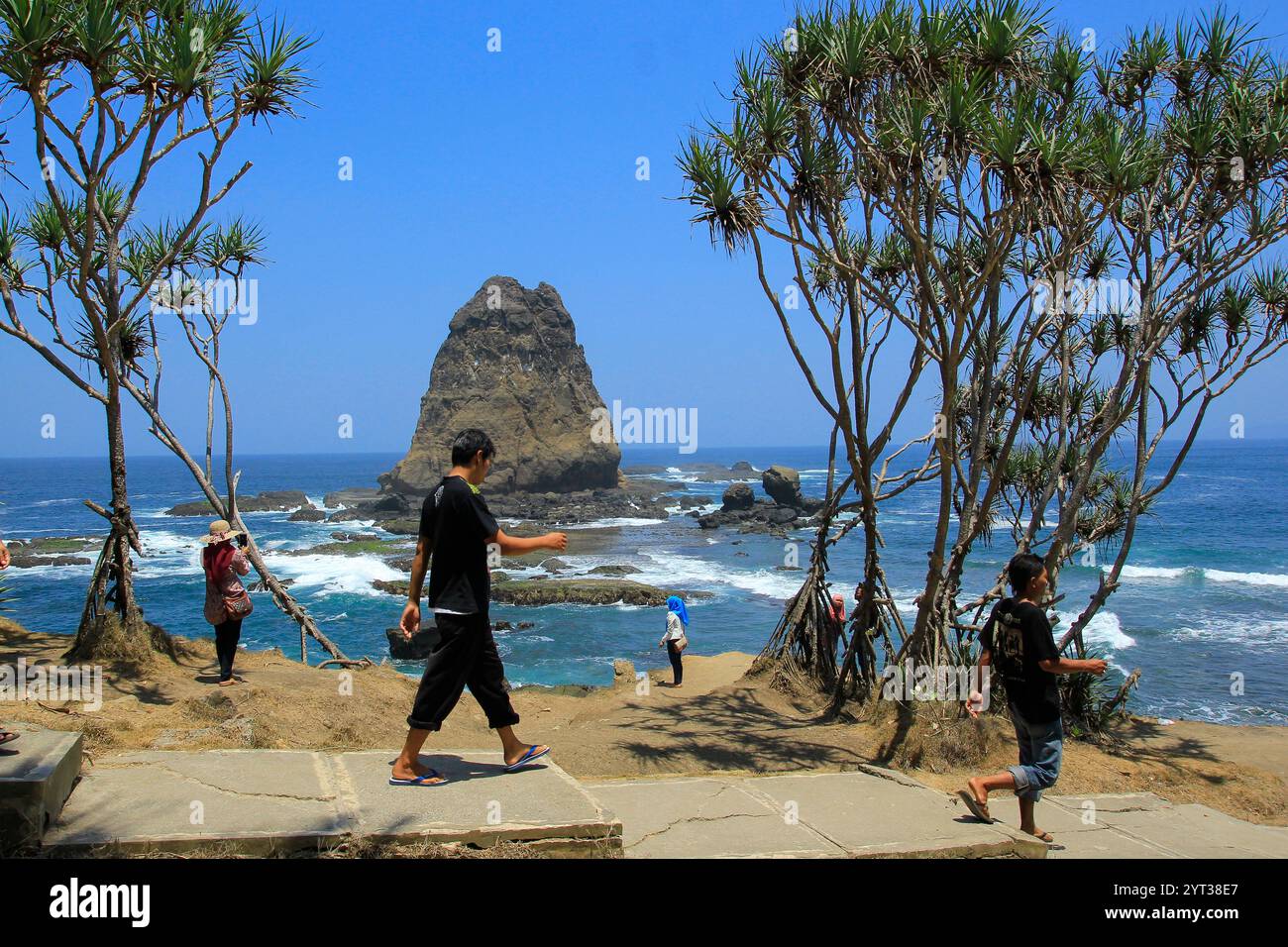 Local tourists visit Papuma Beach. Tanjung Papuma is a type of beach ...