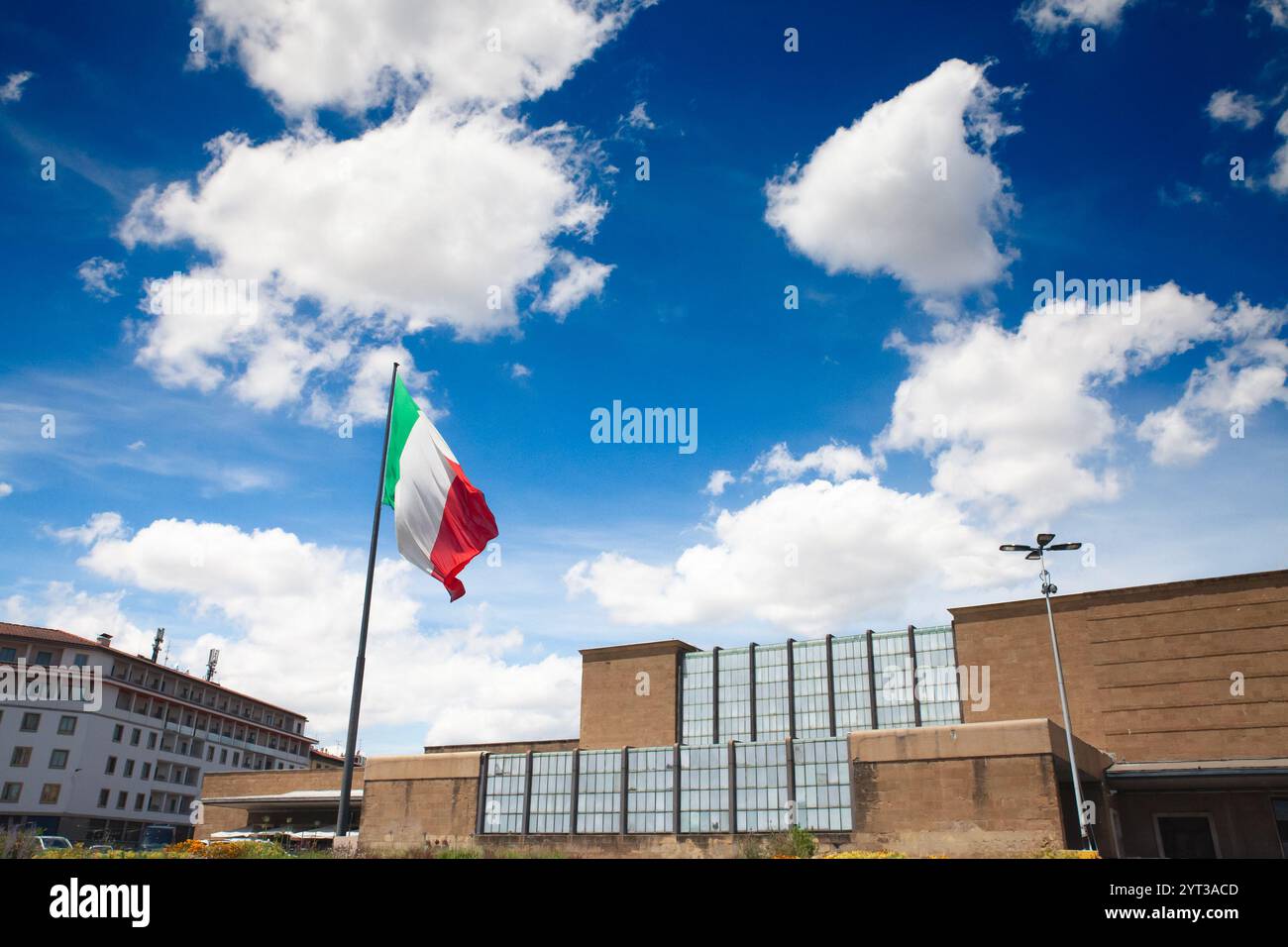 An Italian flag waving in the air against the sky in Florence, Italy. The image symbolizes ...