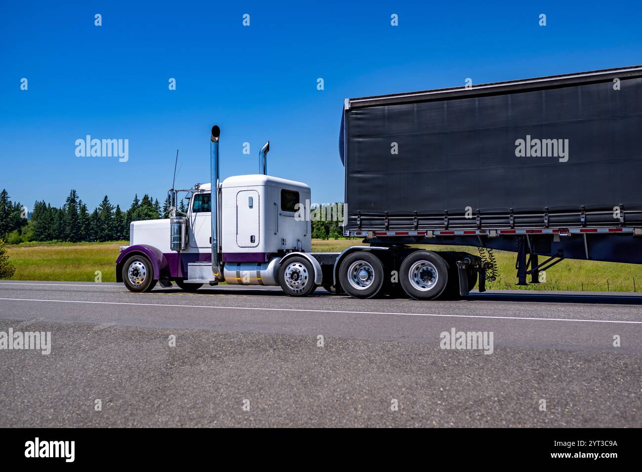 Industrial white and purple big rig classic semi truck with extended ...