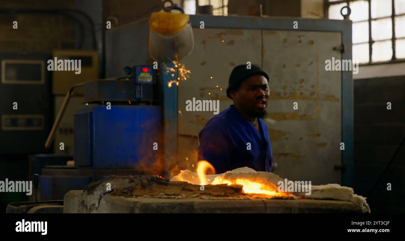 Metal being melted in furnace at workshop Stock Photo - Alamy