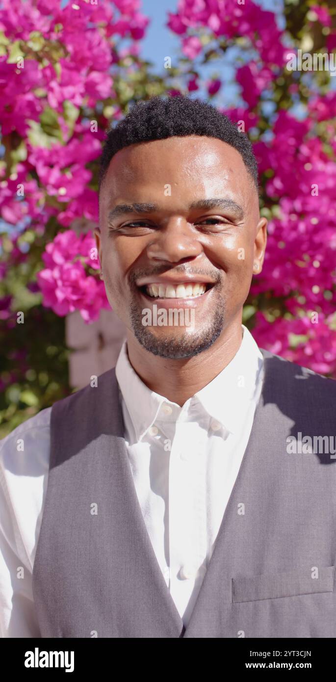 Vertical image of portrait of happy african american man looking at camera and smiling Stock ...