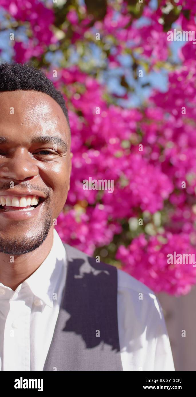 Vertical image of portrait of happy african american man looking at camera and smiling Stock ...
